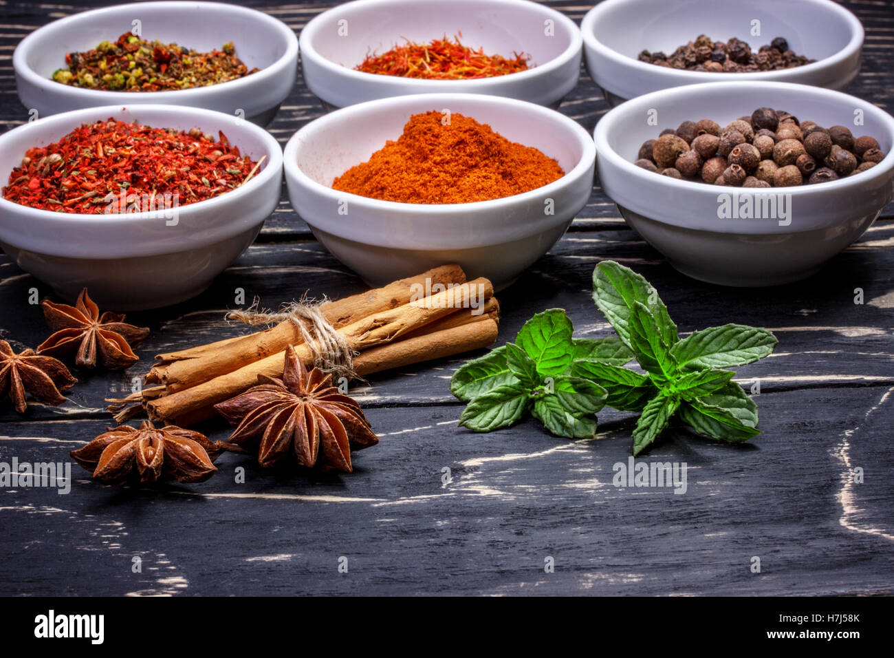 Colorful aromatic Indian spices and herbs on an old oak wooden brown ...
