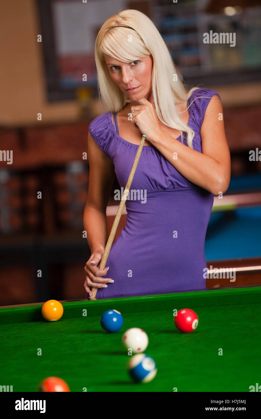 Young blonde women playing snooker Stock Photo - Alamy