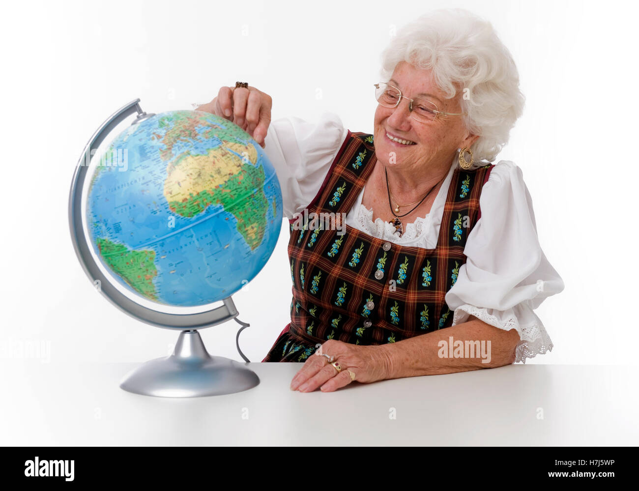 Elderly woman with a globe Stock Photo - Alamy