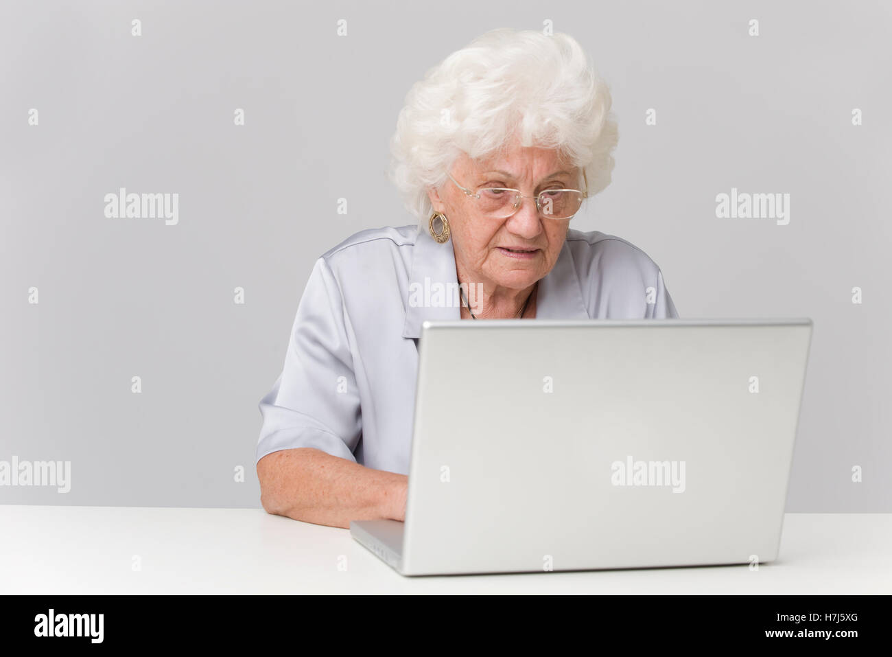 Elderly woman using a laptop Stock Photo - Alamy