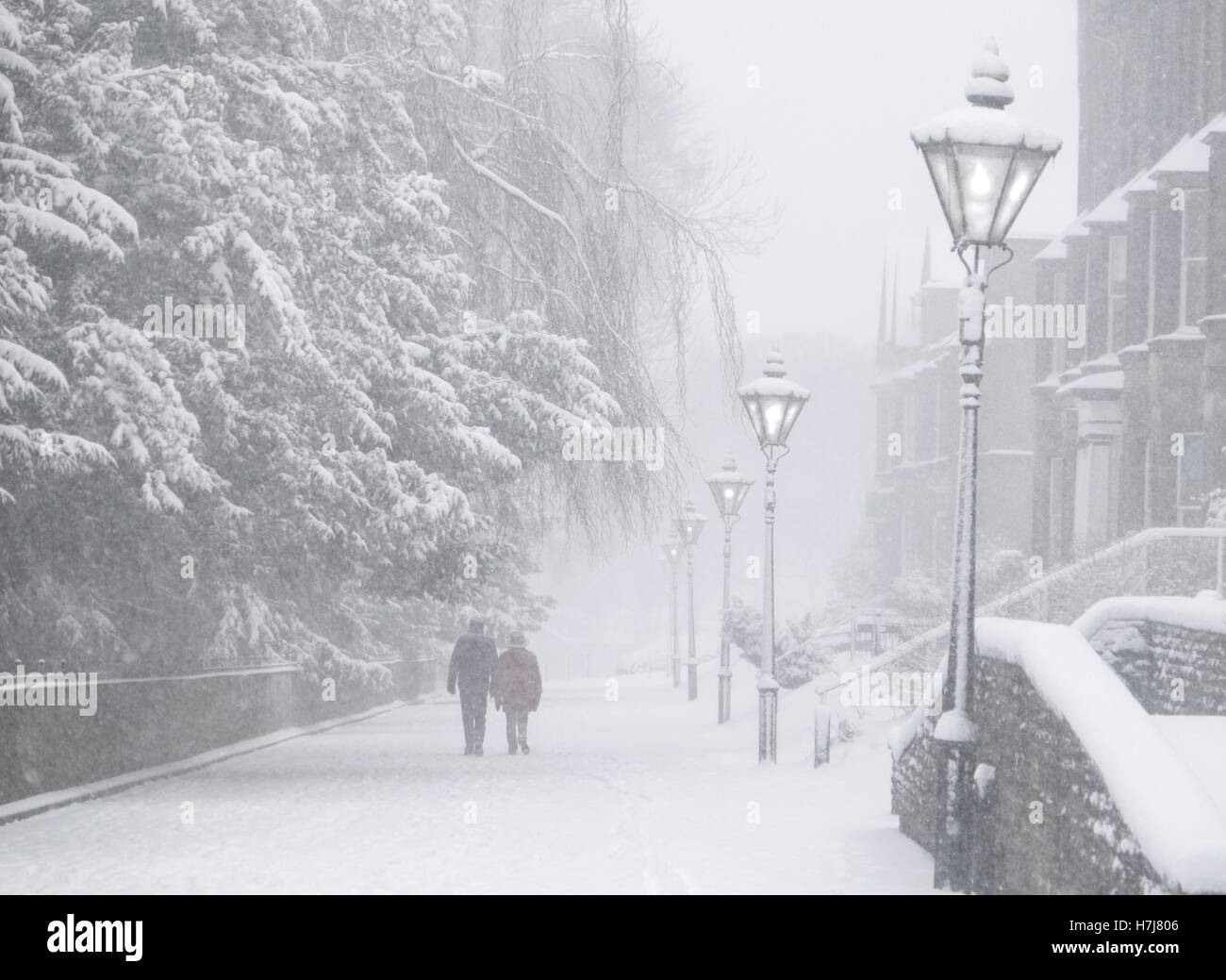 Buxton,Derbyshire in heavy snow. Two people walking on Broad Walk in ...