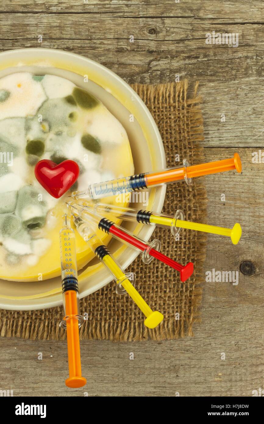 Moldy pudding and syringe. Treatment of the disease. Mold and ...