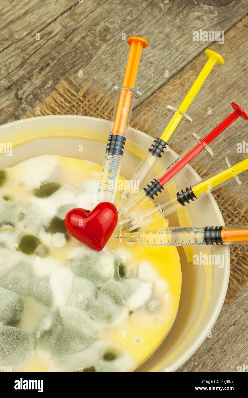 Moldy pudding and syringe. Treatment of the disease. Mold and ...