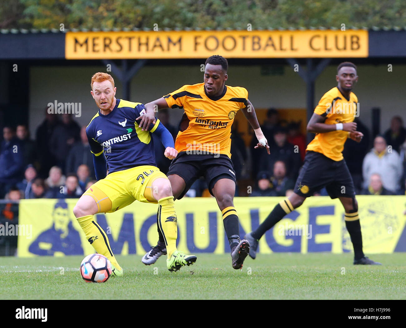 Merstham's Kristian Campbell (left) and Oxford United's Ryan Taylor ...