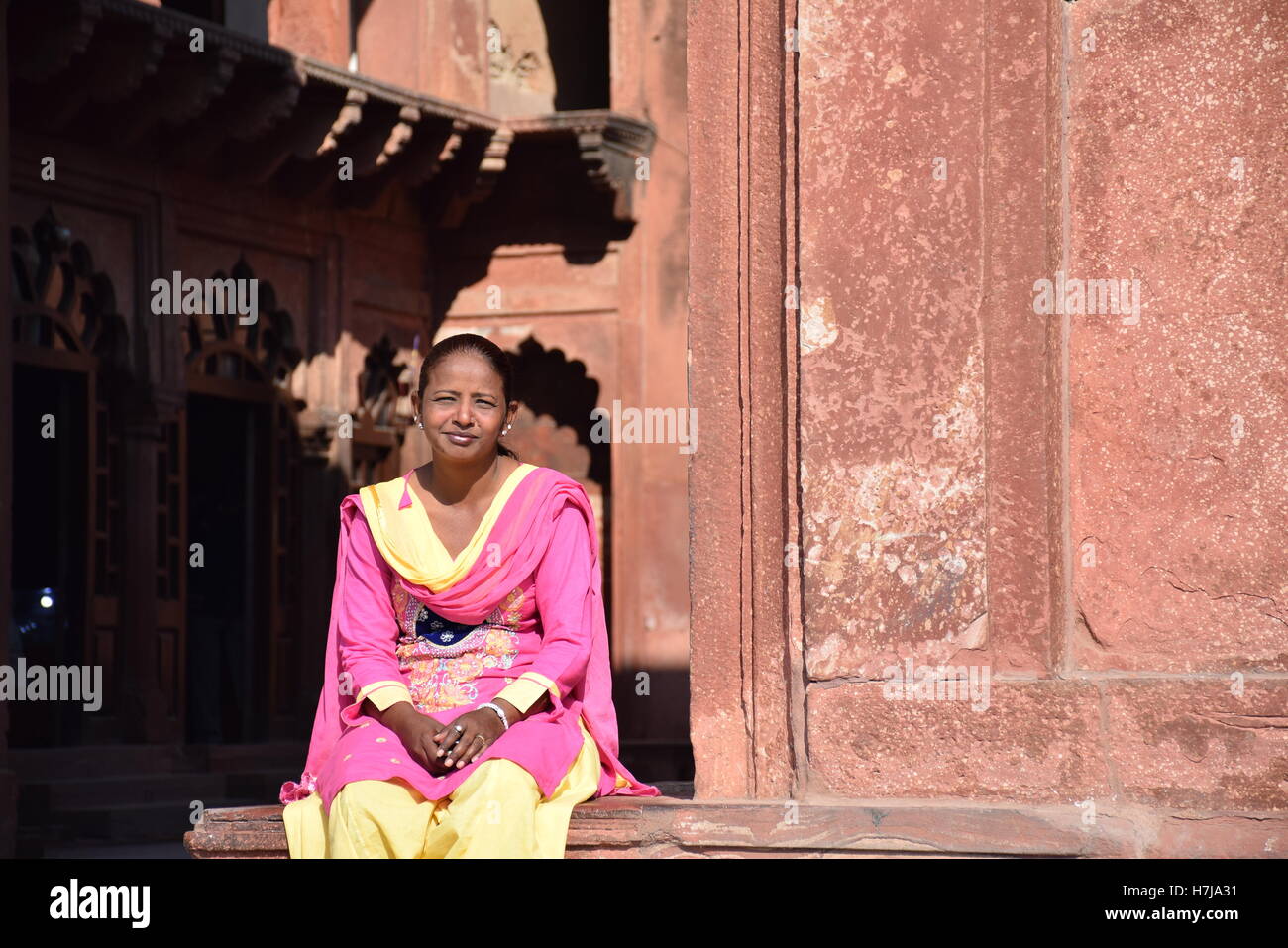 Indian girl sitting and smiling inside Red fort in Agra, Uttar Pradesh ...