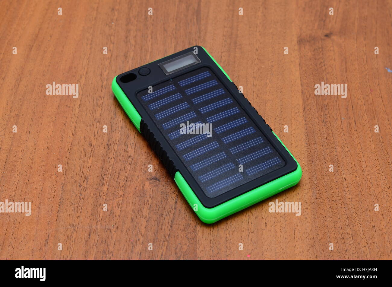 Holding a smart phone while charging with solar charger Stock Photo - Alamy