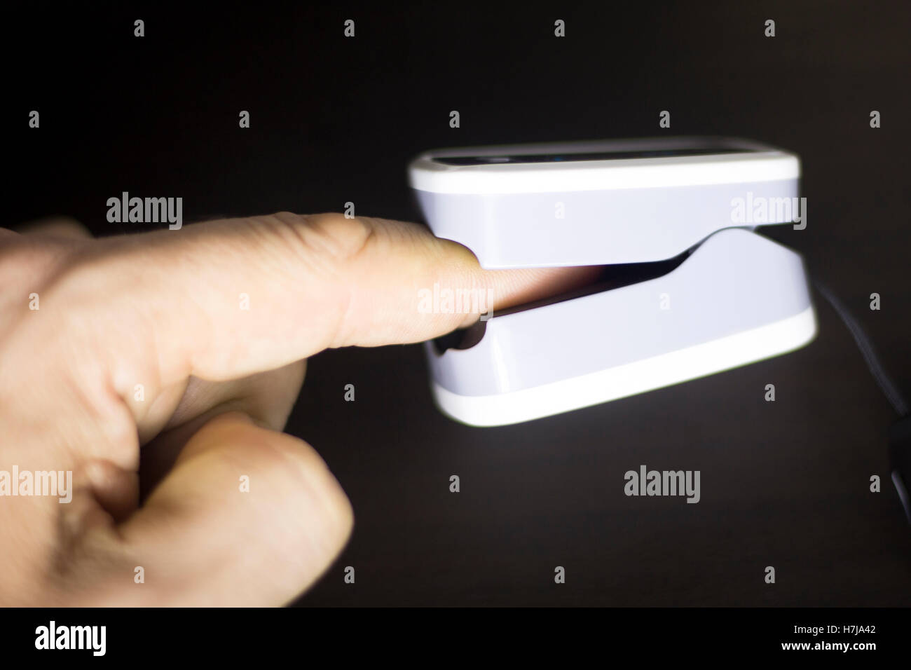 Portable hand held domestic cardiac finger pulse rate meter to show ...