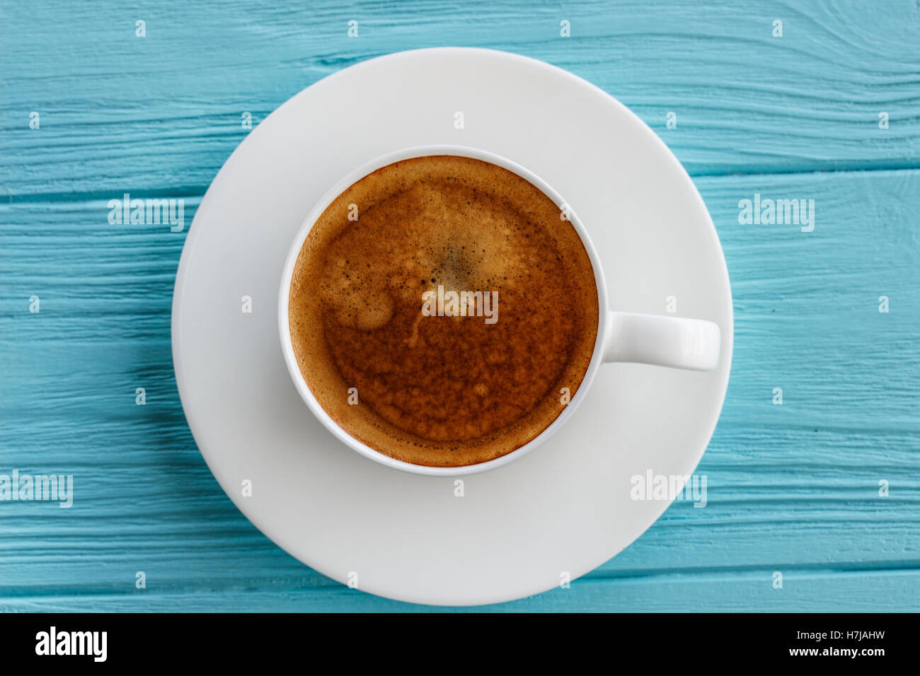 Coffee mug with white flowers and notes good morning on blue rustic ...