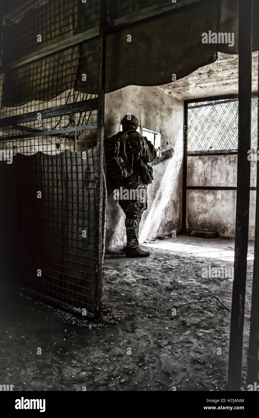 Hidden soldier during military operation watches outside Stock Photo ...