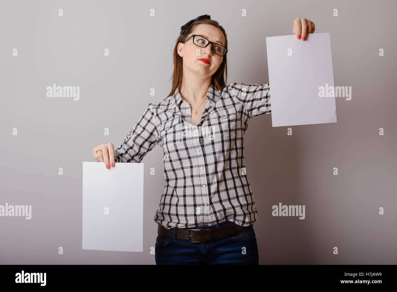 Attractive woman holding paper blank in her hands Stock Photo - Alamy