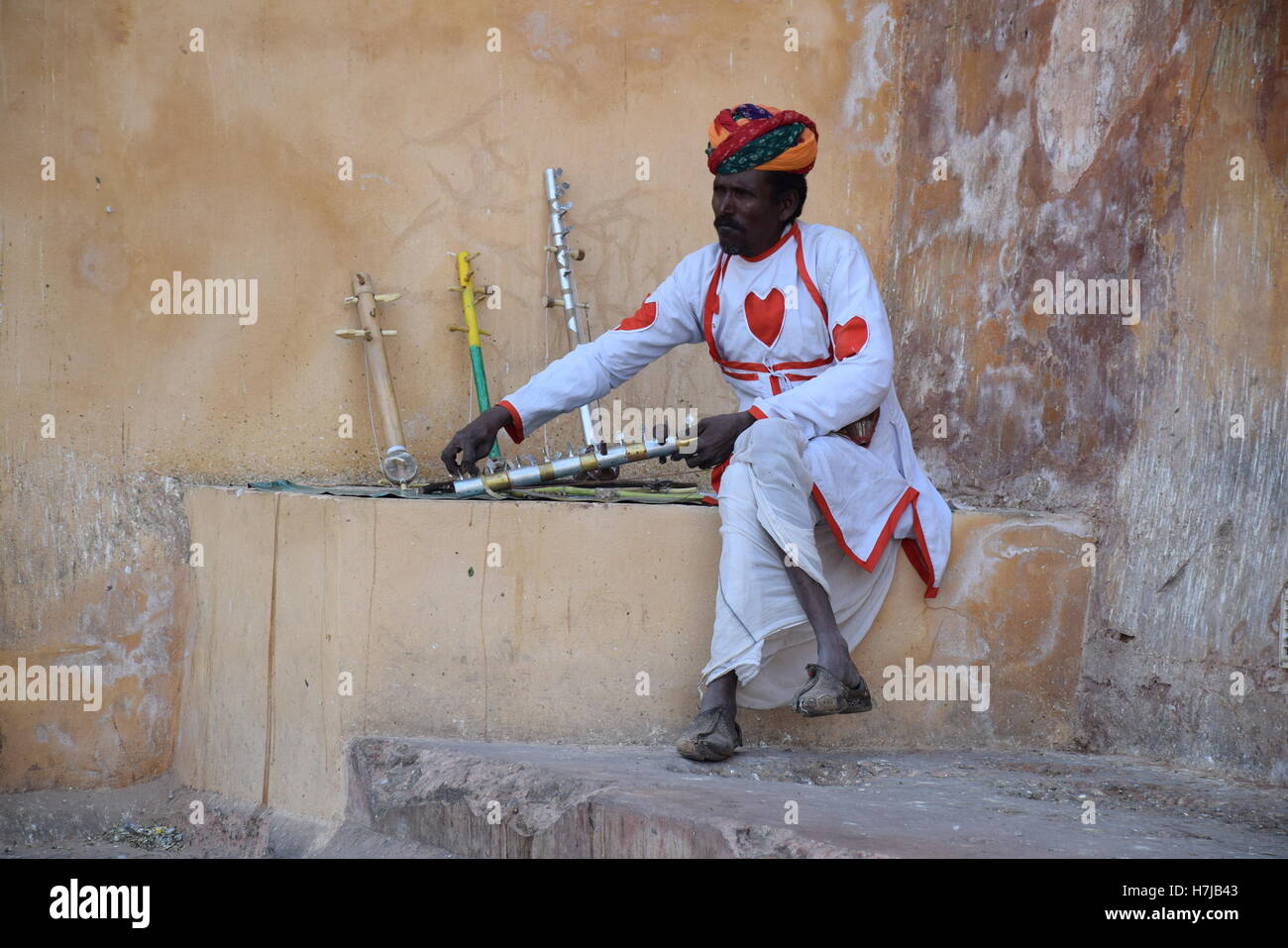 Indian man with traditional musical instrument ravanhatha outside Amber ...