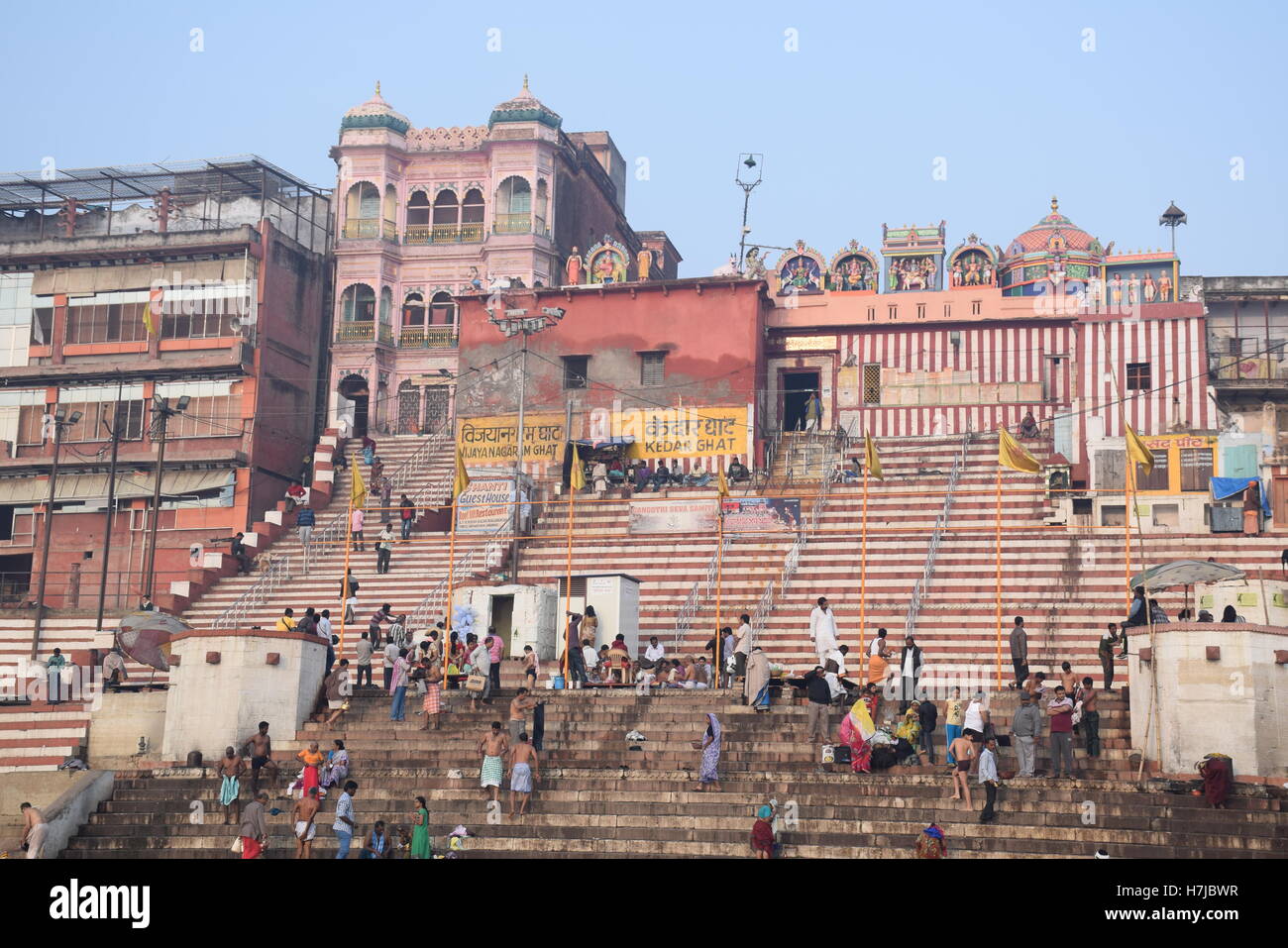 Indian people doing different activities in the morning on the ghats of ...
