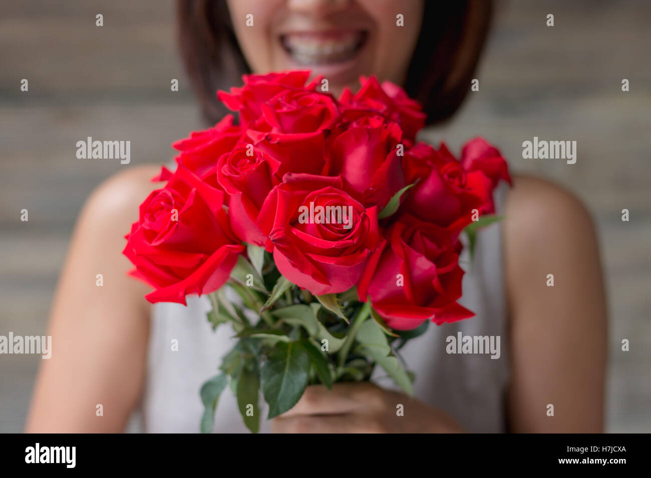 woman holding red rose Stock Photo - Alamy