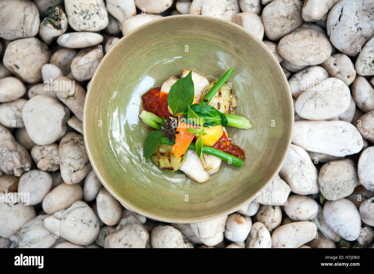Baked sea bass with ginger leaf, local young vegetables and spicy ...