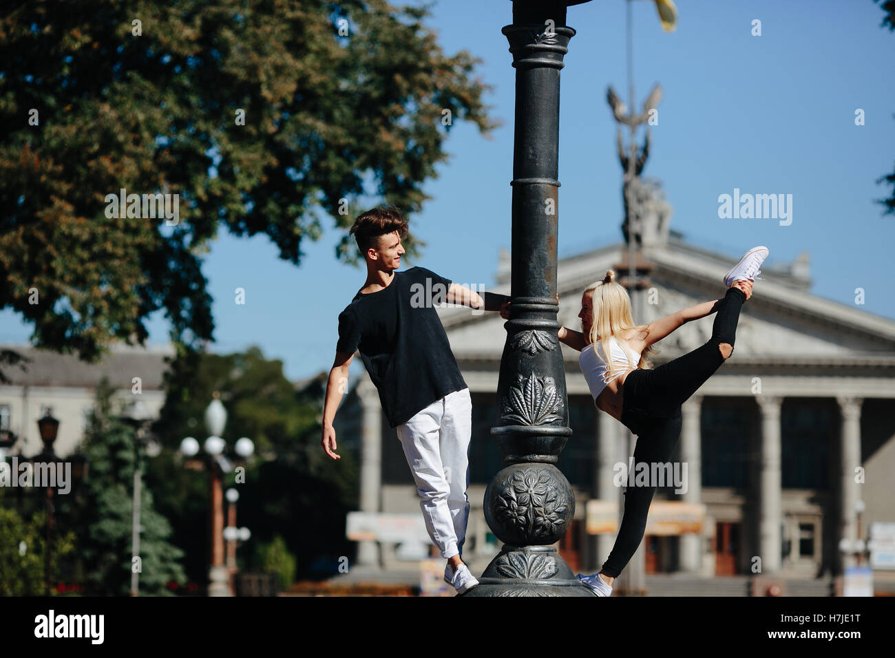man and woman performing acrobatic tricks Stock Photo - Alamy
