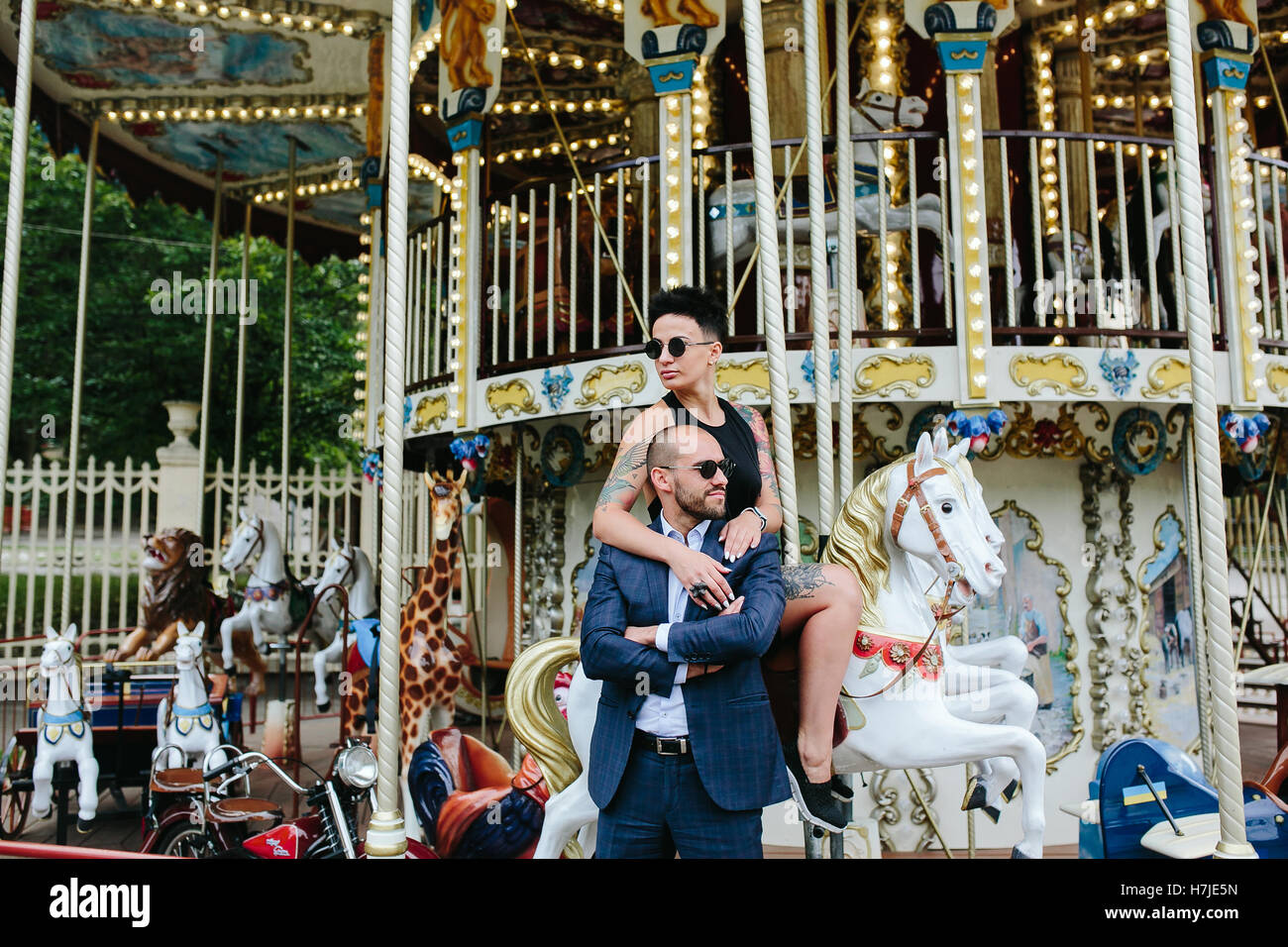 adult man and woman on a carousel Stock Photo - Alamy