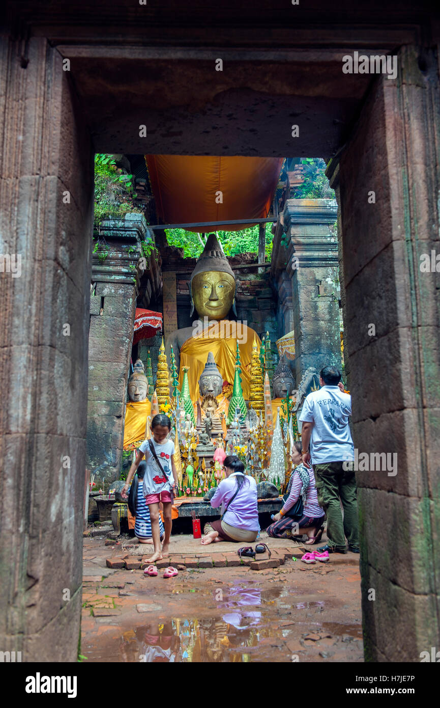 Devotees pray at Wat Phu, a ruined Khmer Hindu temple complex in ...