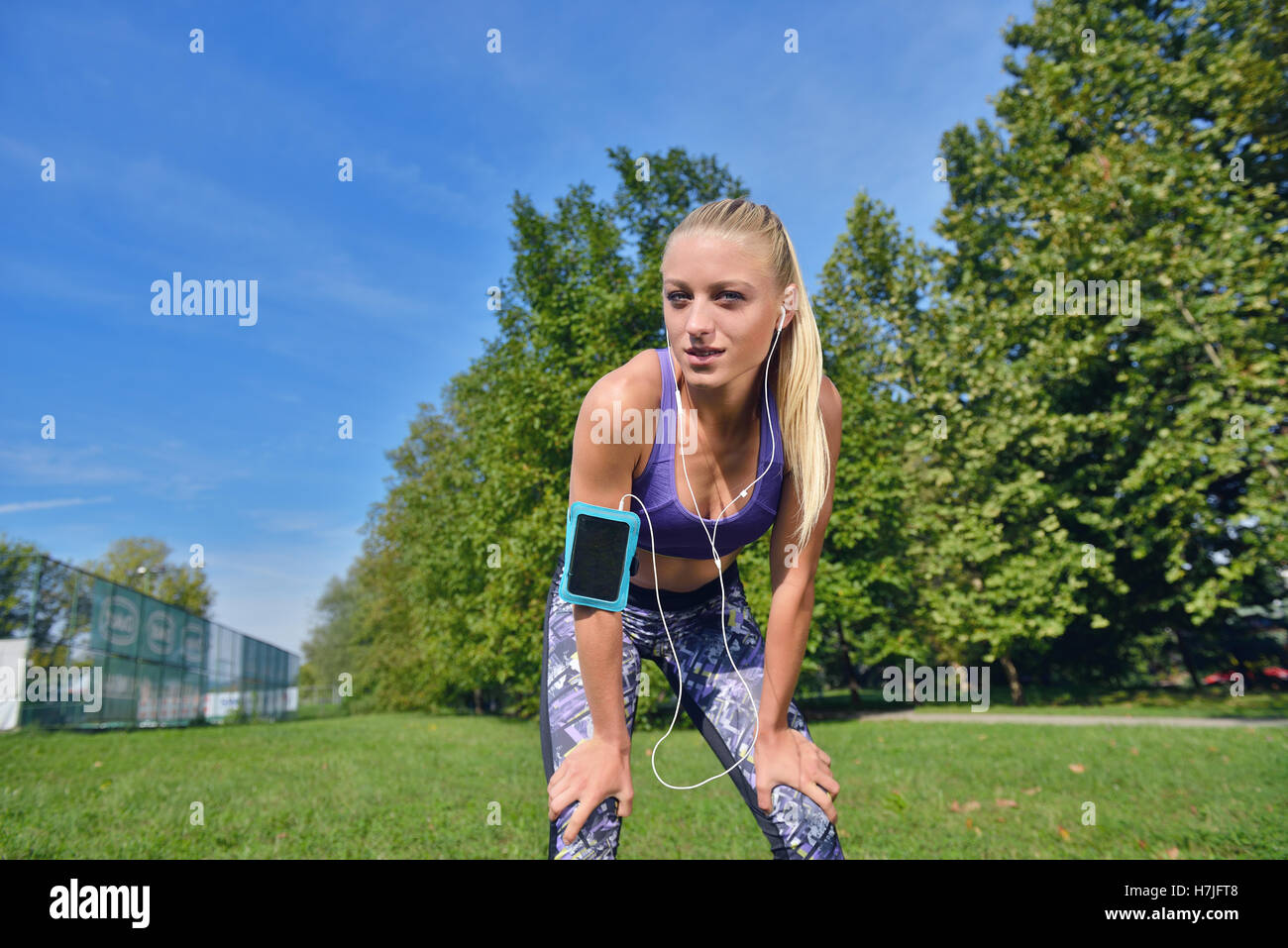Young woman taking rest after jogging - workout at the park Stock Photo ...