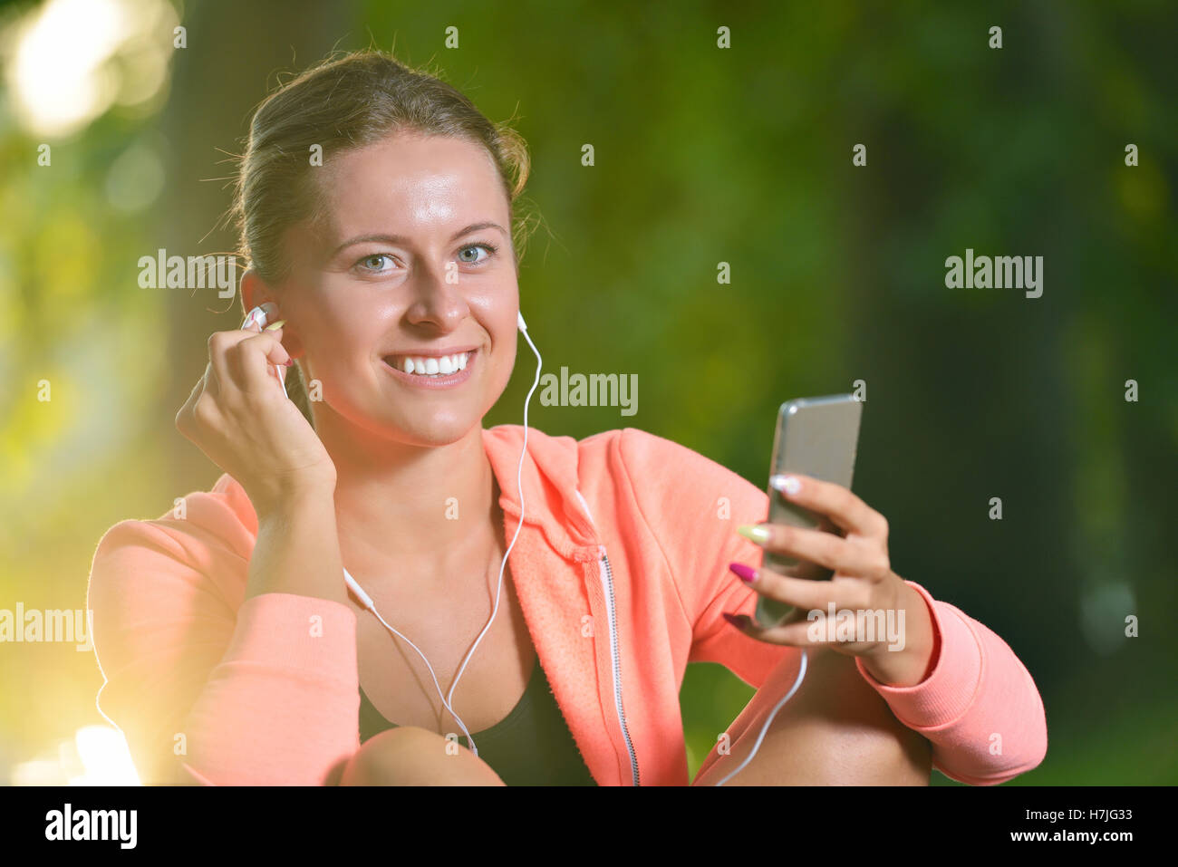 Young woman taking rest after jogging - workout at the park Stock Photo ...