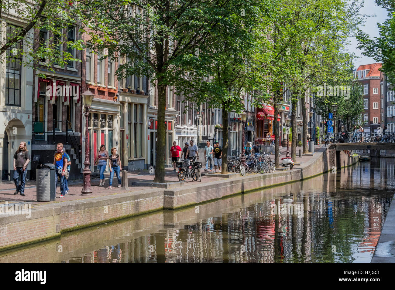 Locals and tourist walking along one of Hollands beautiful canals in ...