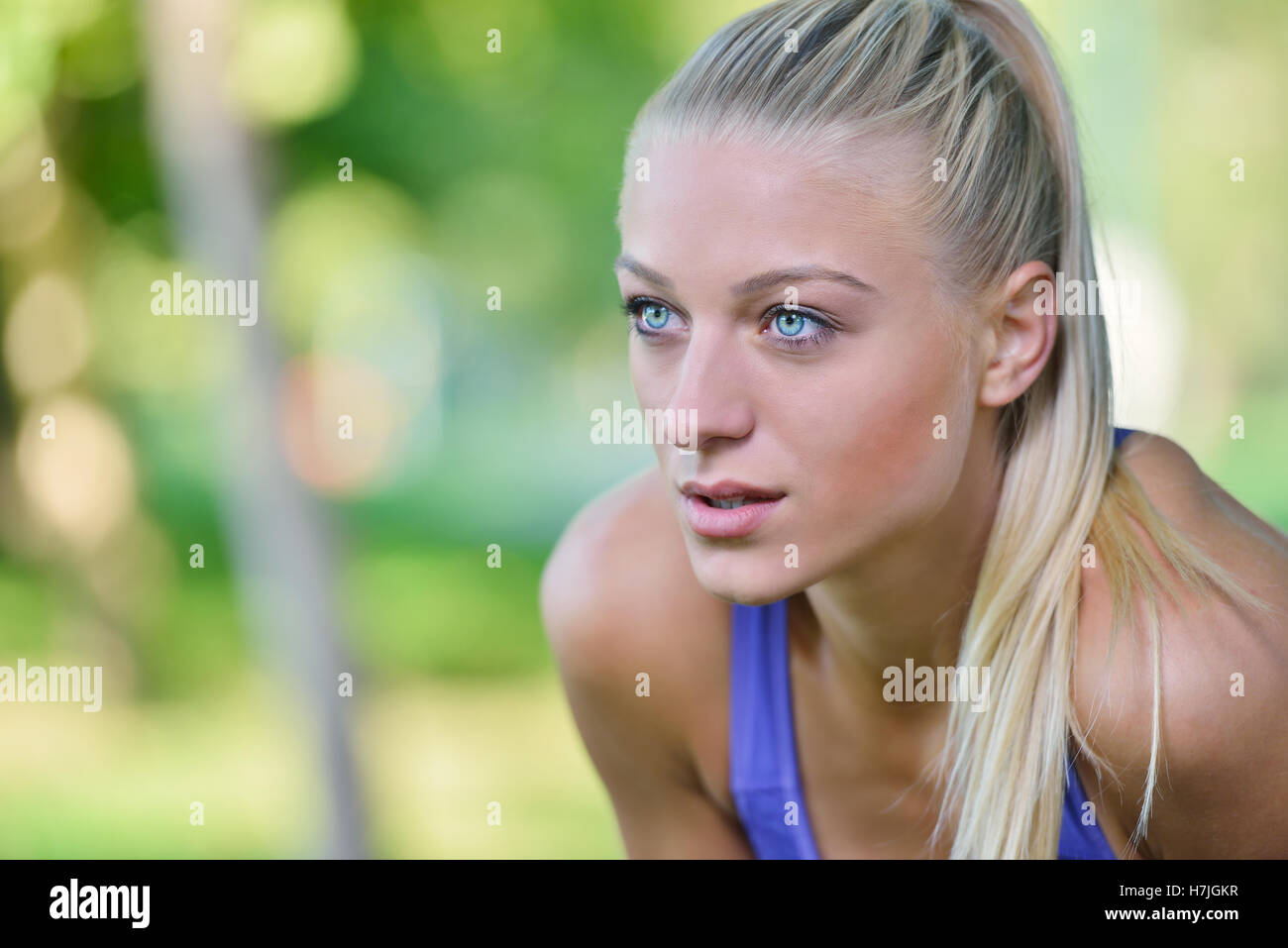 Young woman taking rest after jogging - workout at the park Stock Photo ...