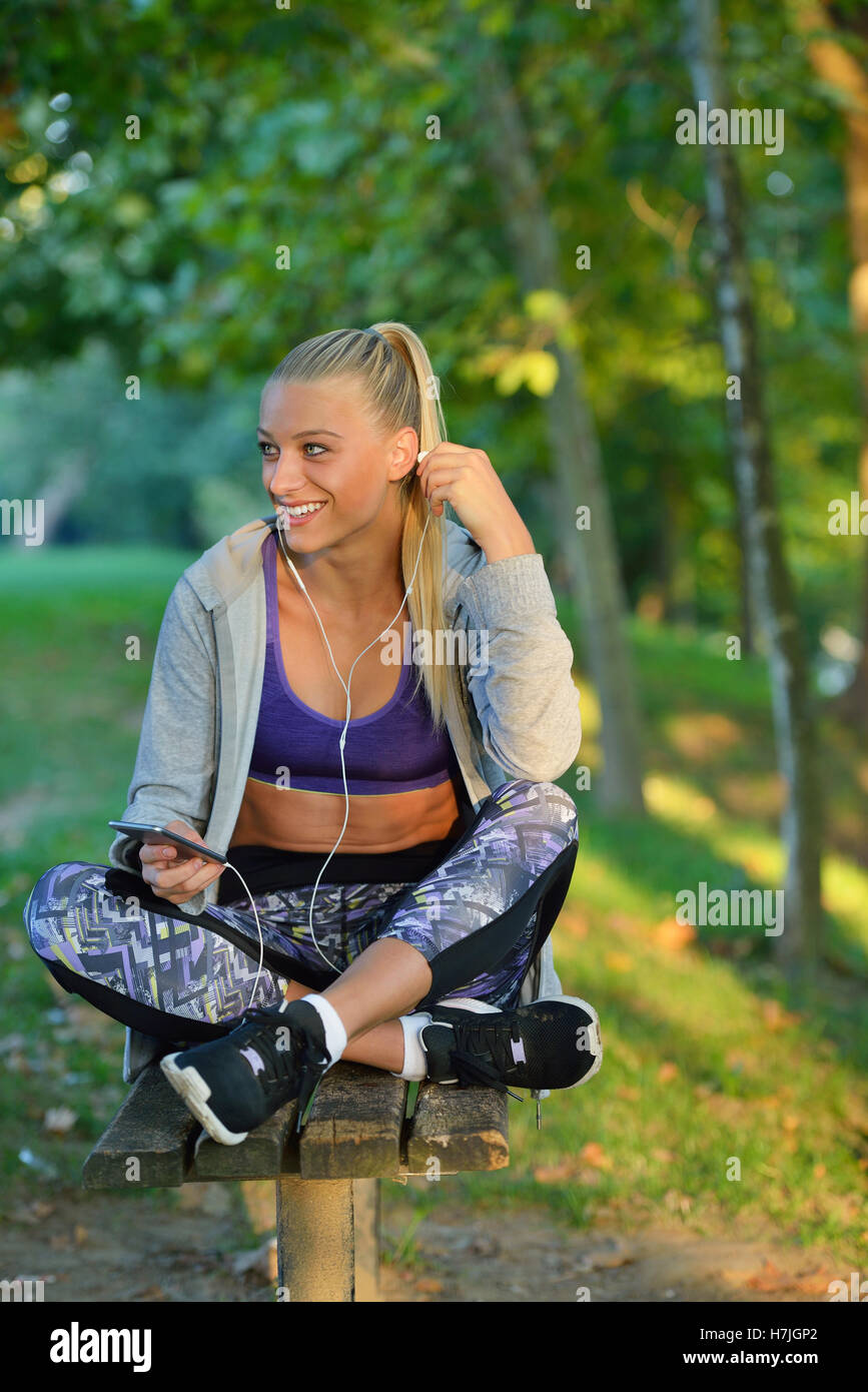 Young woman taking rest after jogging - workout at the park Stock Photo ...