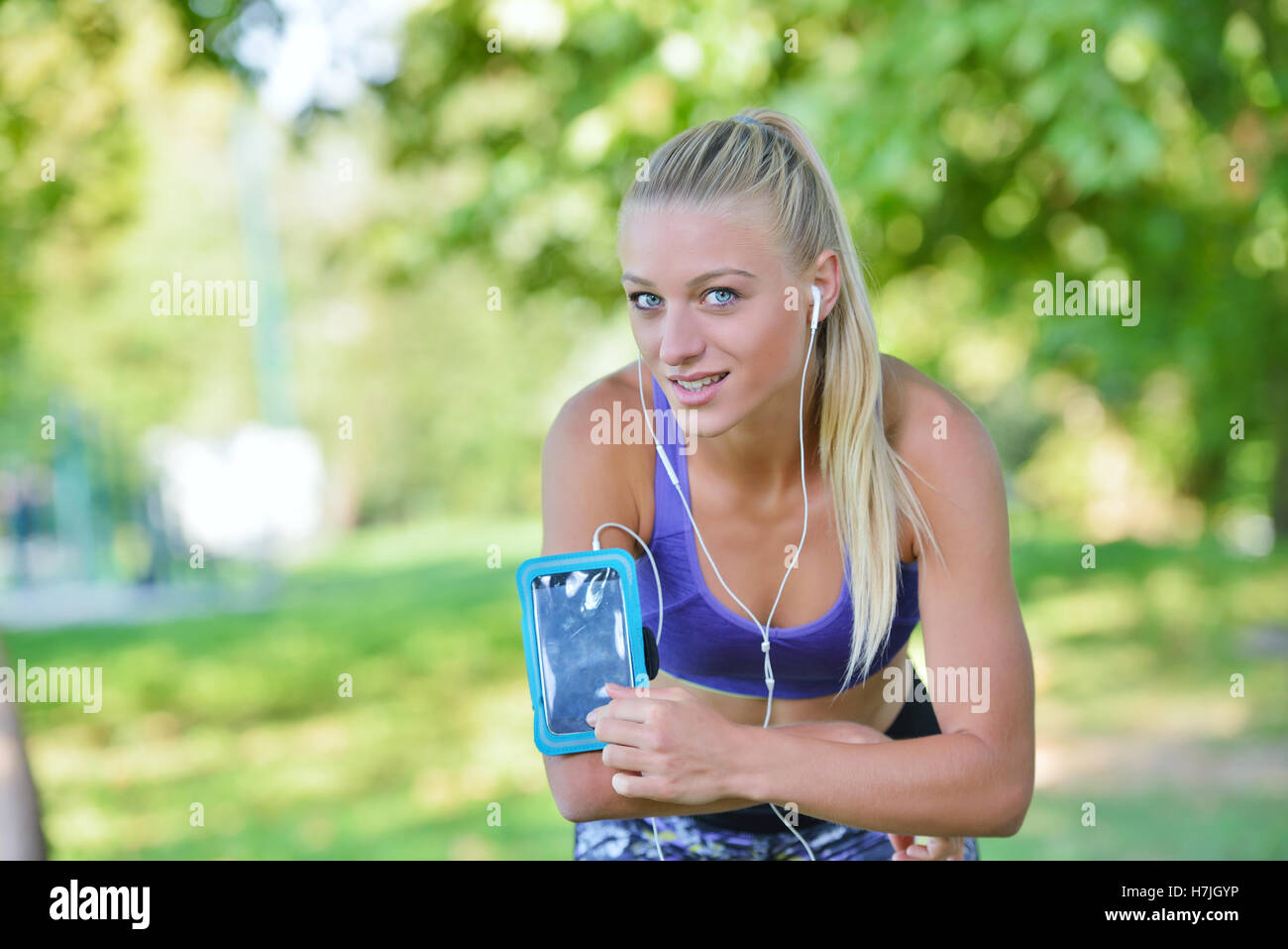 Young woman taking rest after jogging - workout at the park Stock Photo ...
