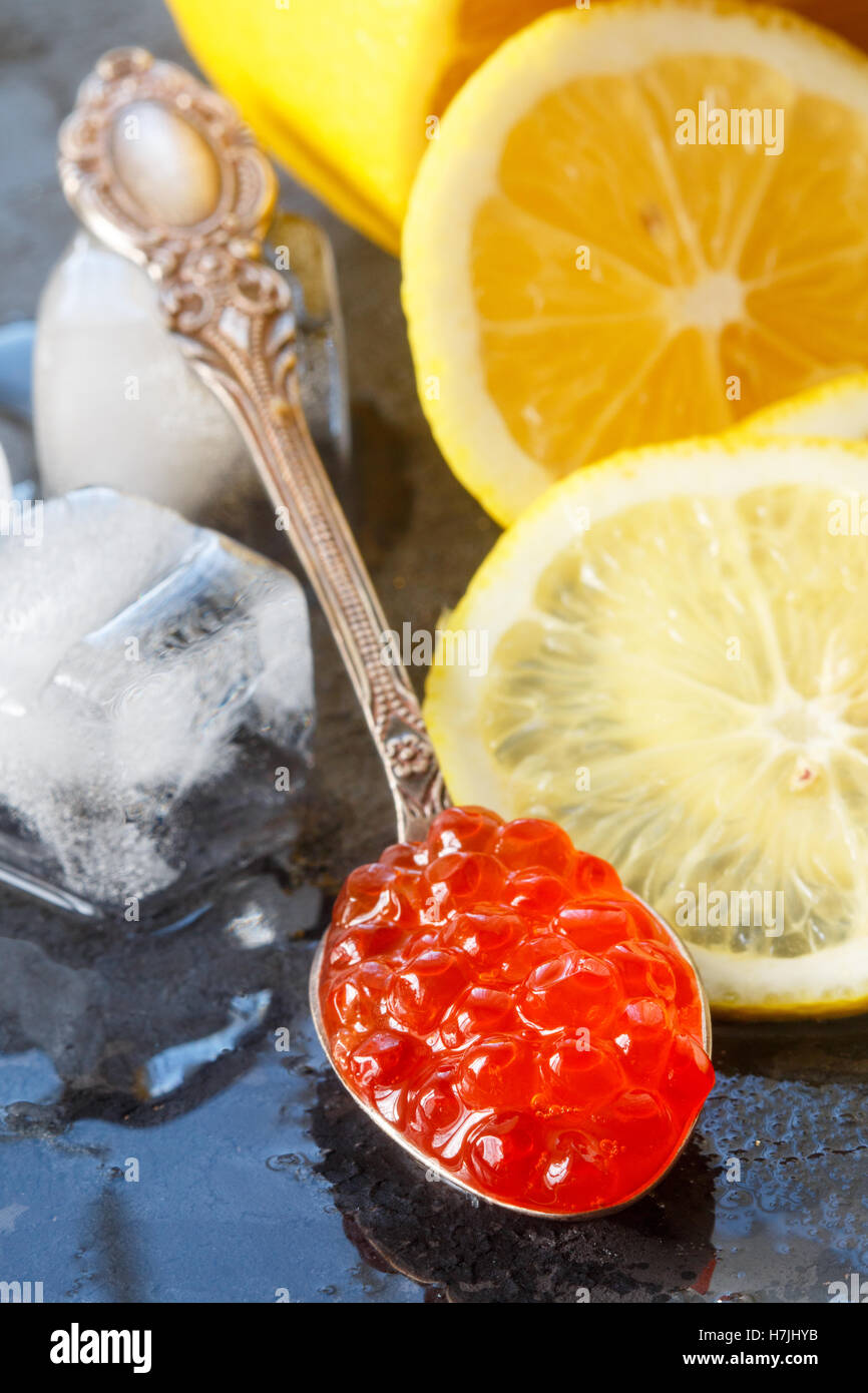Red salmon caviar and lemon. Selective focus Stock Photo - Alamy