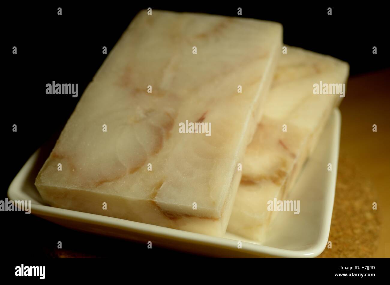 Frozen pollock fillets on a plate, ready for preparation Stock Photo ...