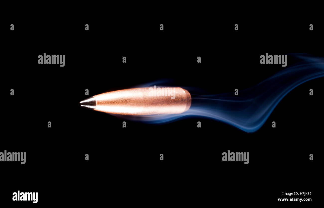 Polymer tipped bullet with a copper coating and smoke behind Stock ...