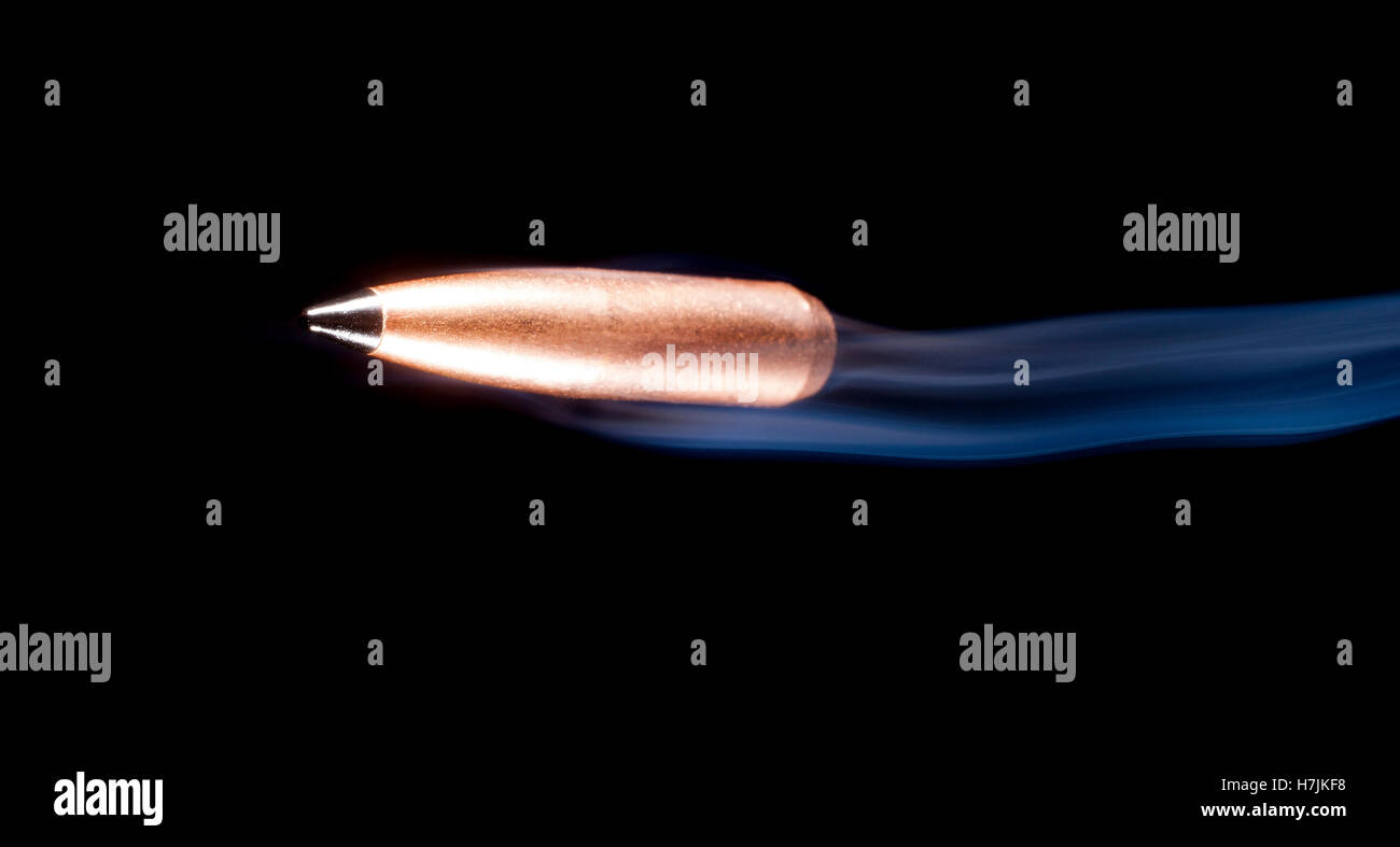 Copper plated bullet with a black polymer tip with smoke Stock Photo ...