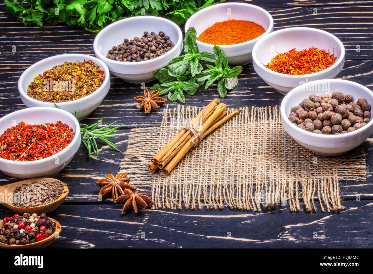 Colorful aromatic spices and herbs on an old oak wooden brown ...