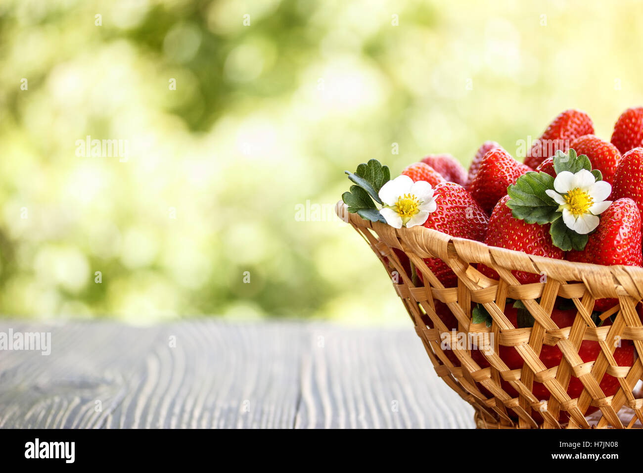strawberries on a wooden old table outdoors Stock Photo - Alamy