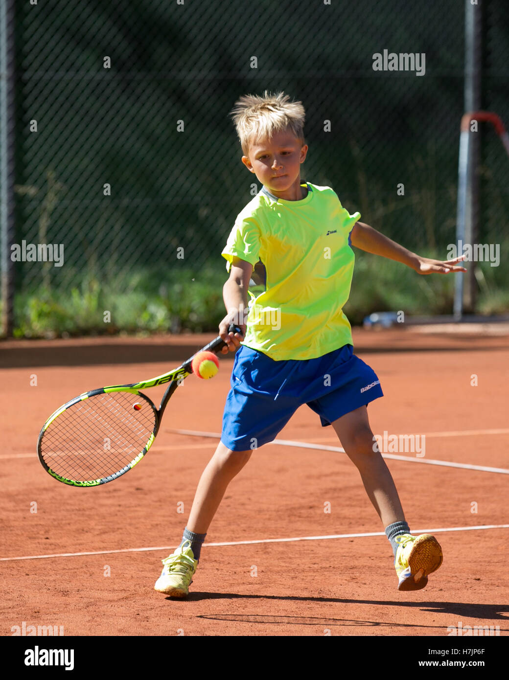 Boy playing tennis at a junior competition Stock Photo - Alamy