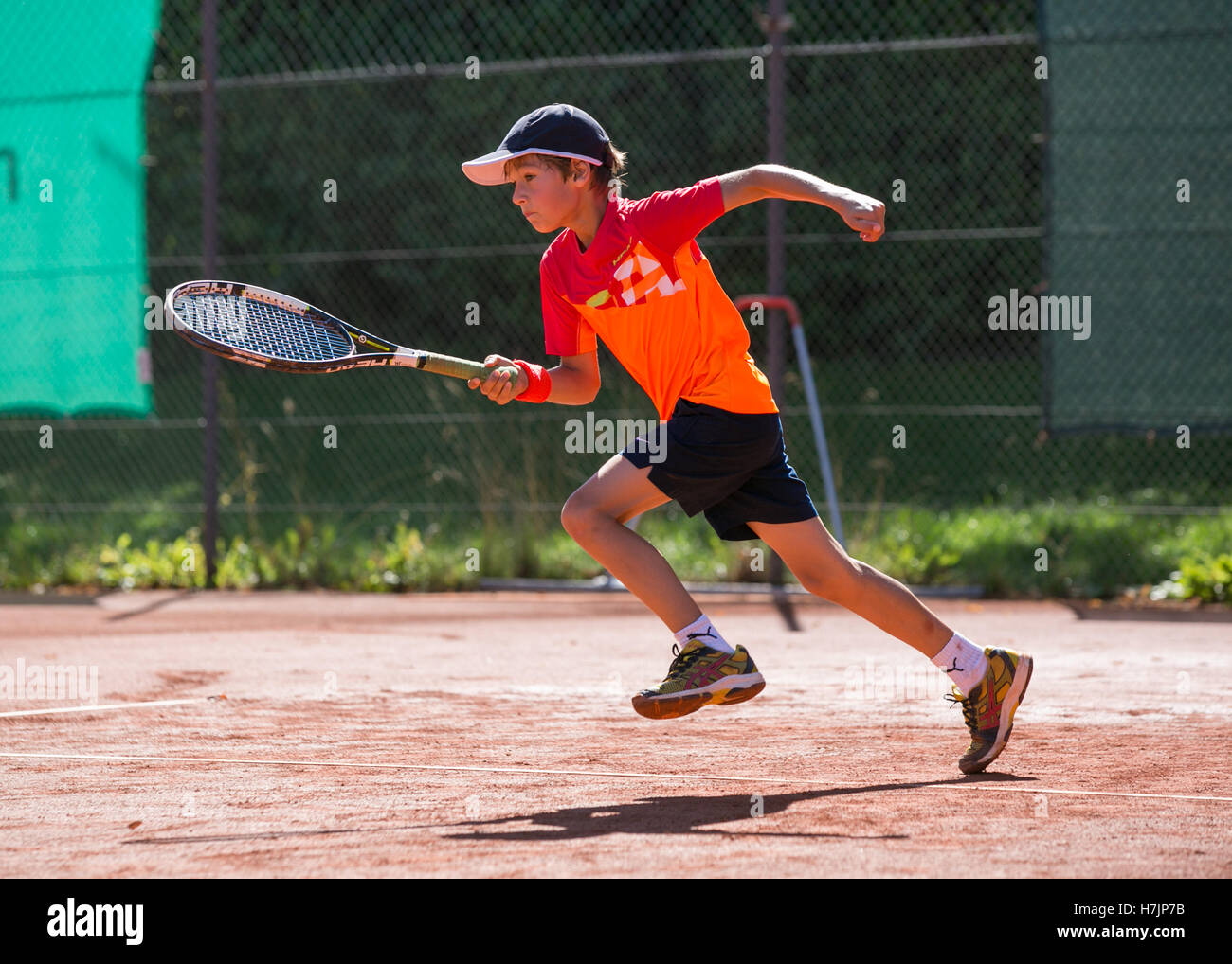 Boy playing tennis at a junior competition Stock Photo - Alamy
