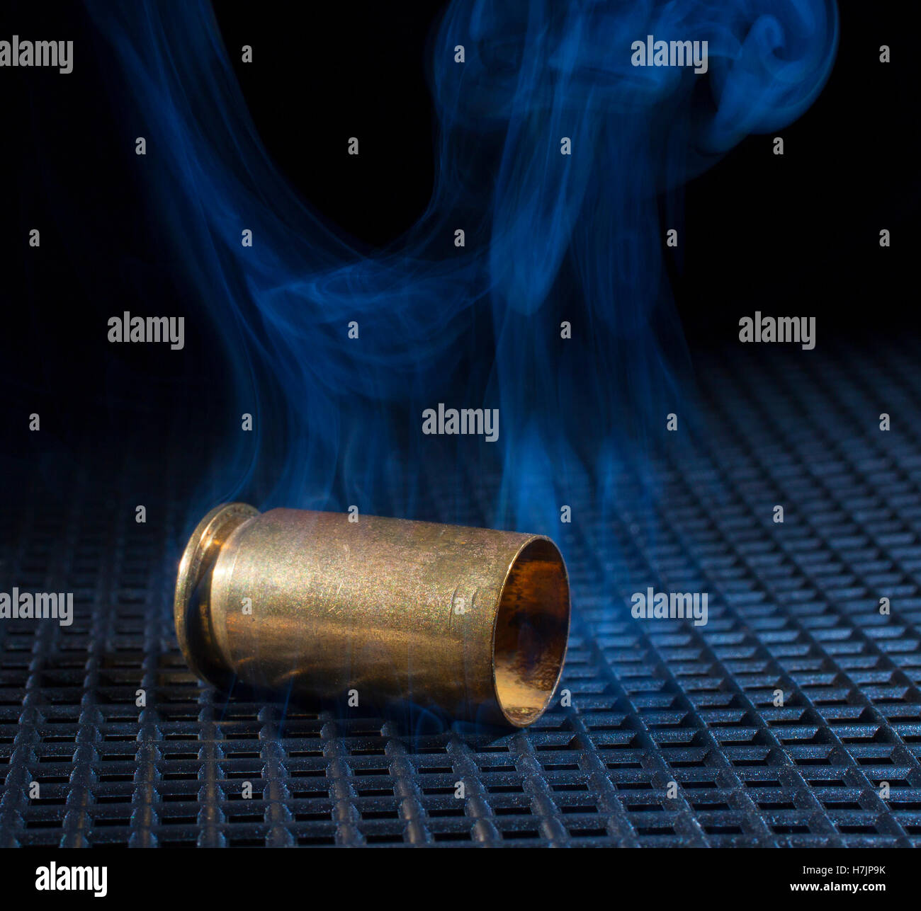 Empty shell from a semi automatic handgun that is smoking Stock Photo ...