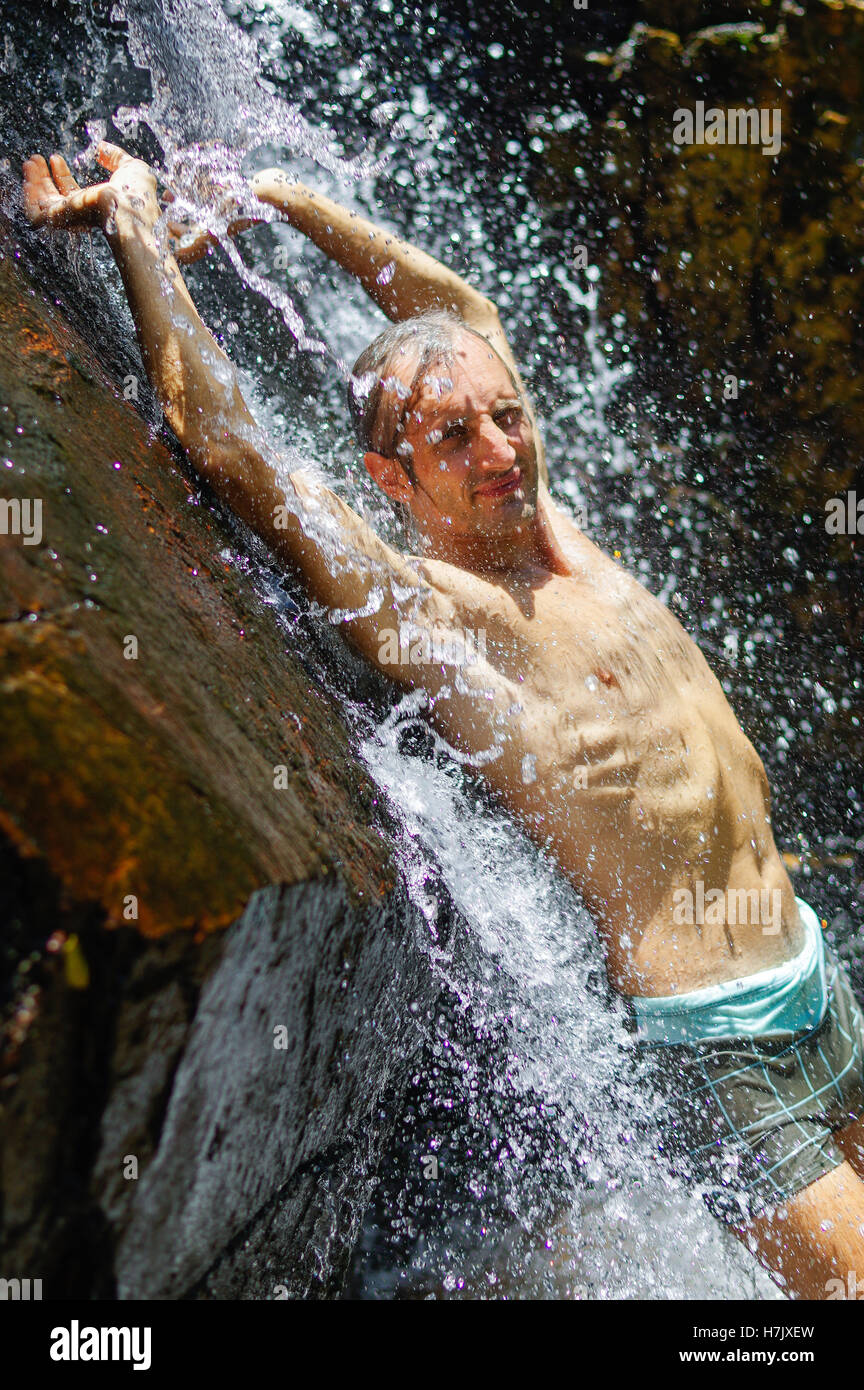 Man bathing under waterfall hi-res stock photography and images - Alamy
