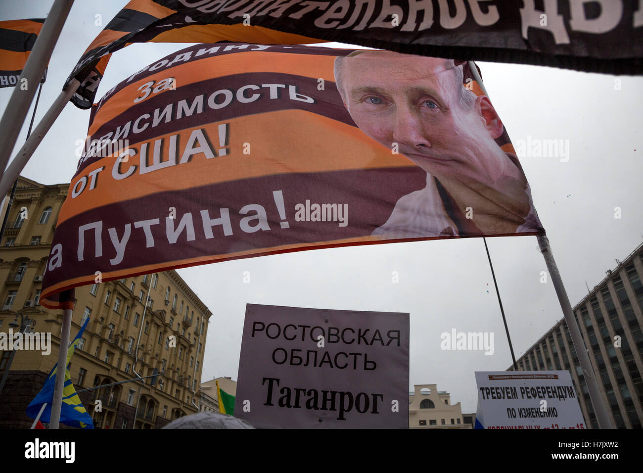 People hold banner with portrait of Vladimir Putin and the inscription ...