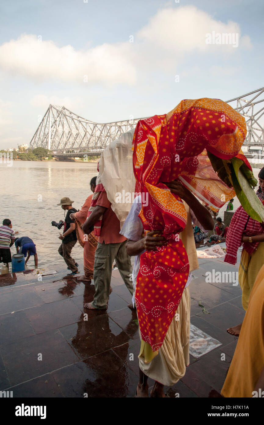 Priest going for kola bou snan puja at mallick ghat kolkata west bengal ...