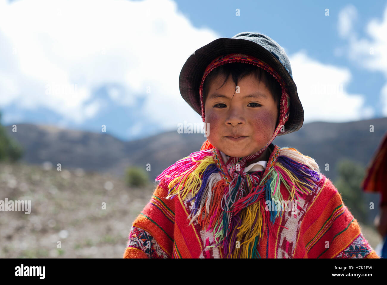 Portrait of a Peruvian boy dressed in colourful traditional handmade ...