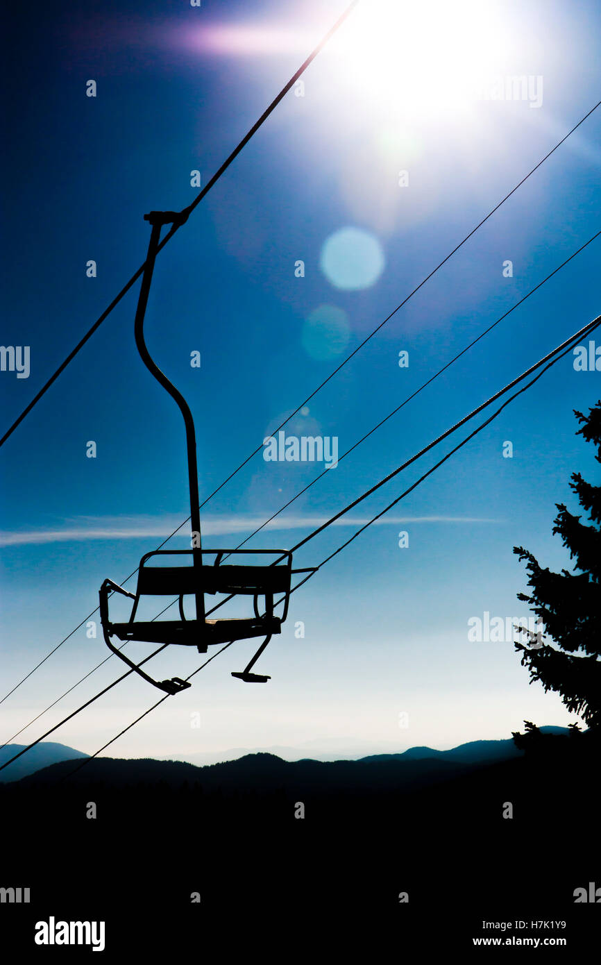 Shot of ski lift with bright sun and clear sky Stock Photo - Alamy