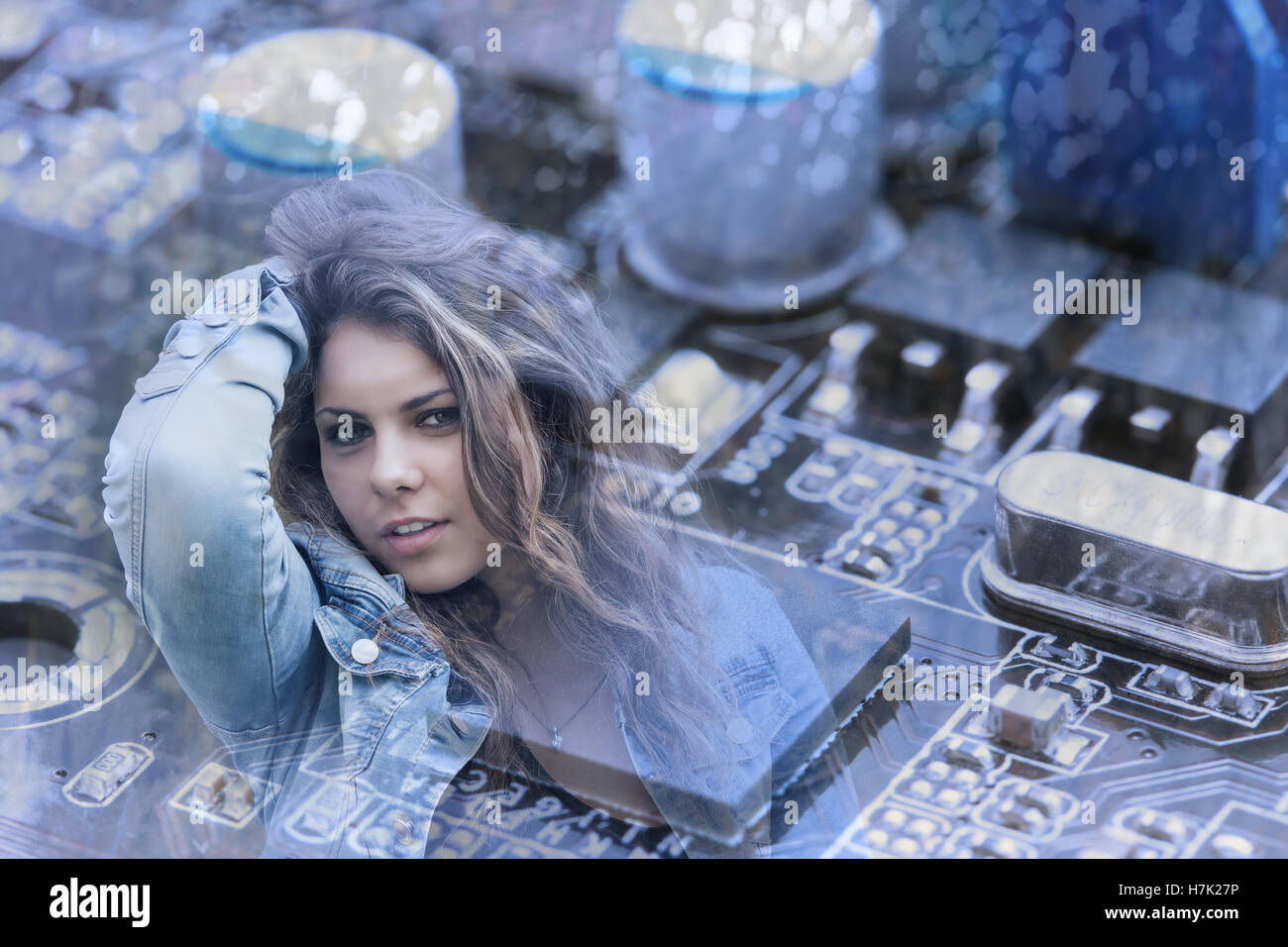 Double exposure of long haired teenage girl and computer motherboard in ...