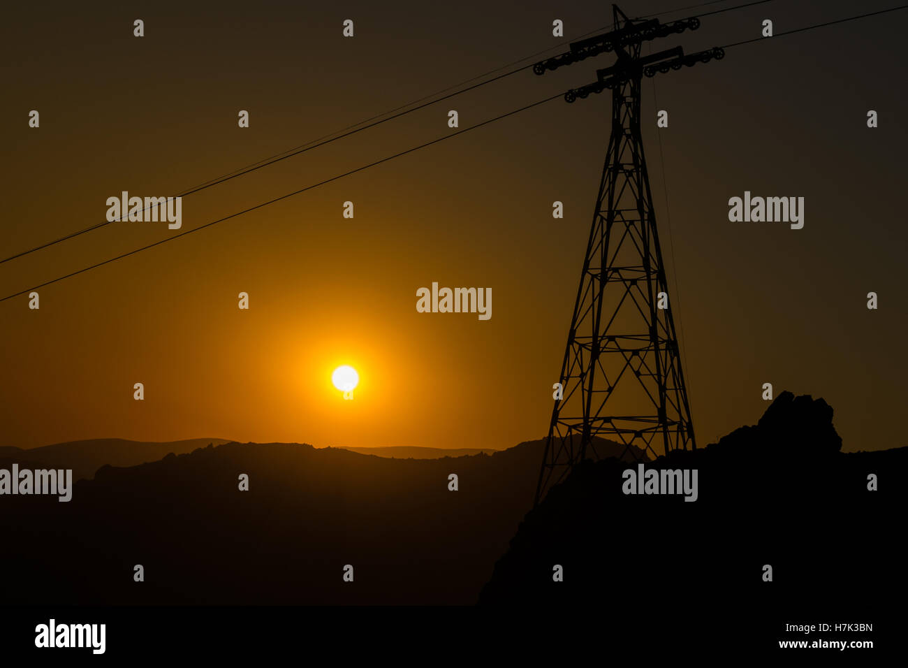 Electricity pylons in sunset Stock Photo - Alamy