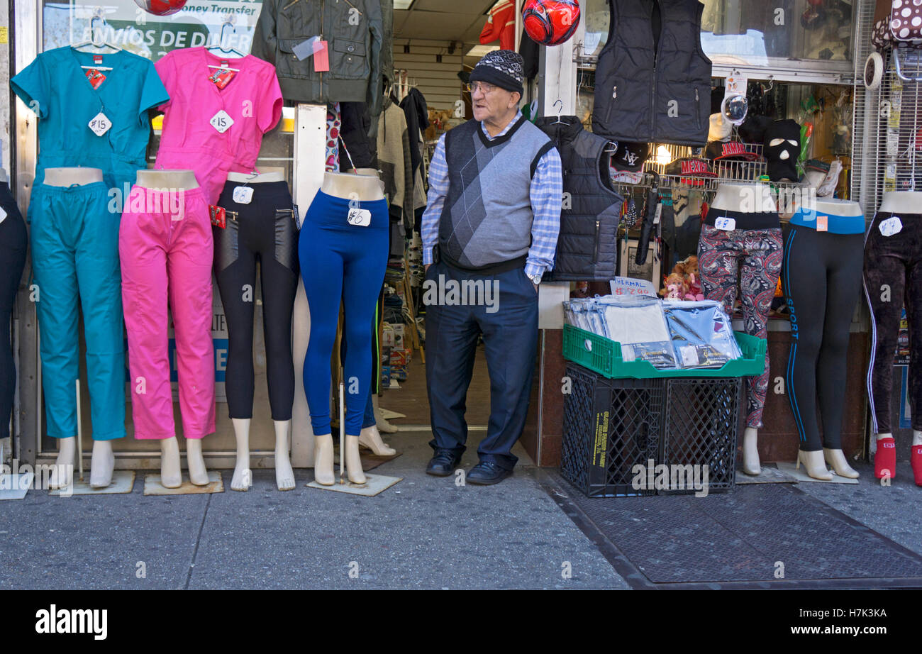 A storekeeper at the doorway to his clothing store in on Roosevelt Ave ...