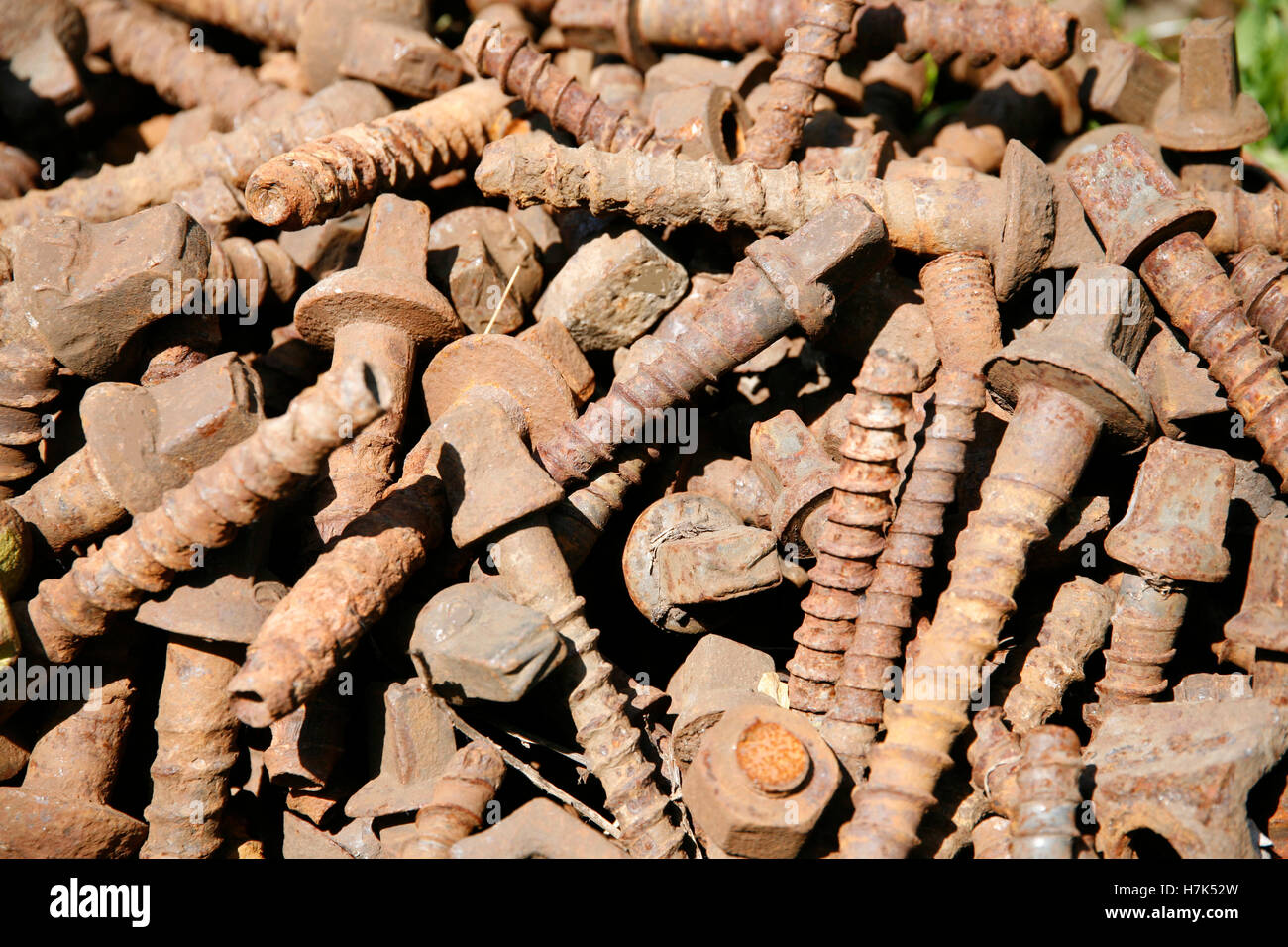 Old rusted bolts sleepers screws as a background Stock Photo - Alamy