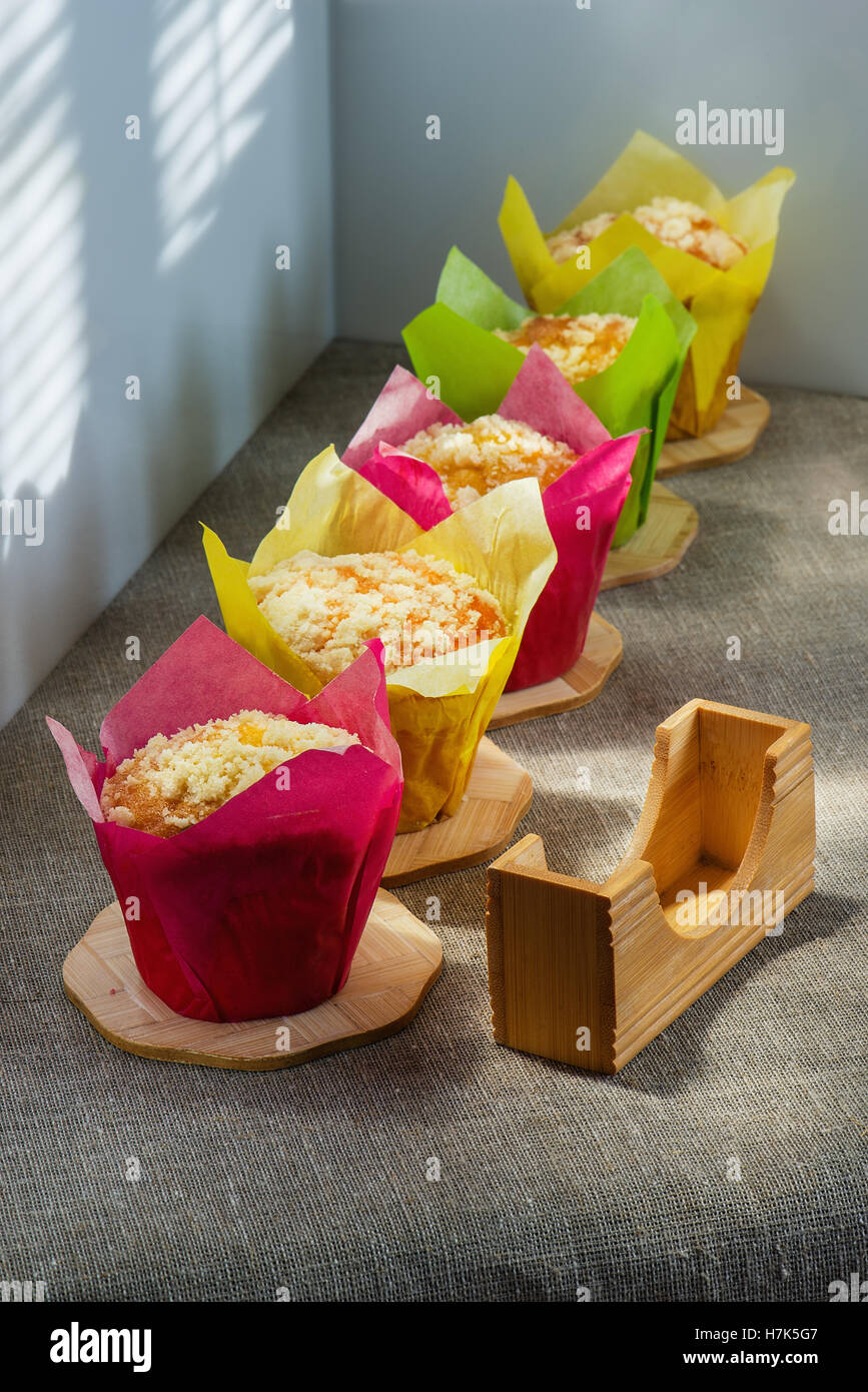 Muffins of different color on wooden supports a cloth Stock Photo - Alamy