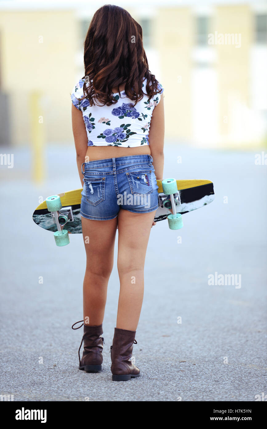 young girl carrying skate board Stock Photo - Alamy