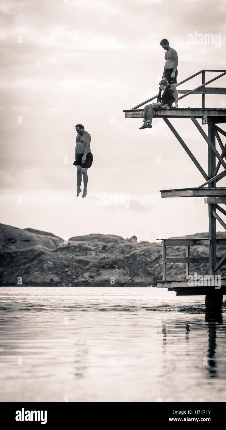 Man jumping from a springboard in Skärhamn, Sweden Stock Photo - Alamy