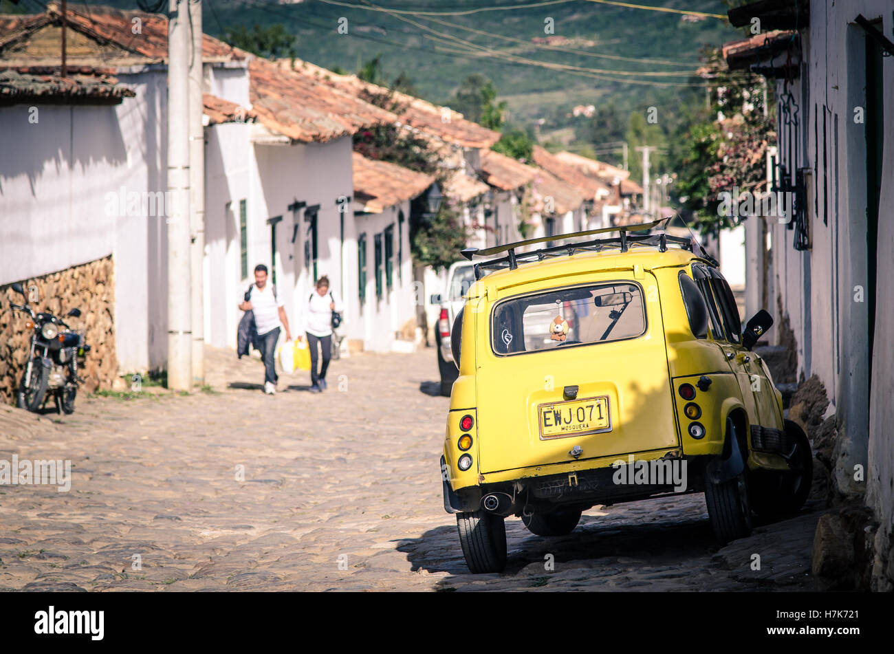 Side street with a yellow car in Villa de Leyva, Colombia Stock Photo ...