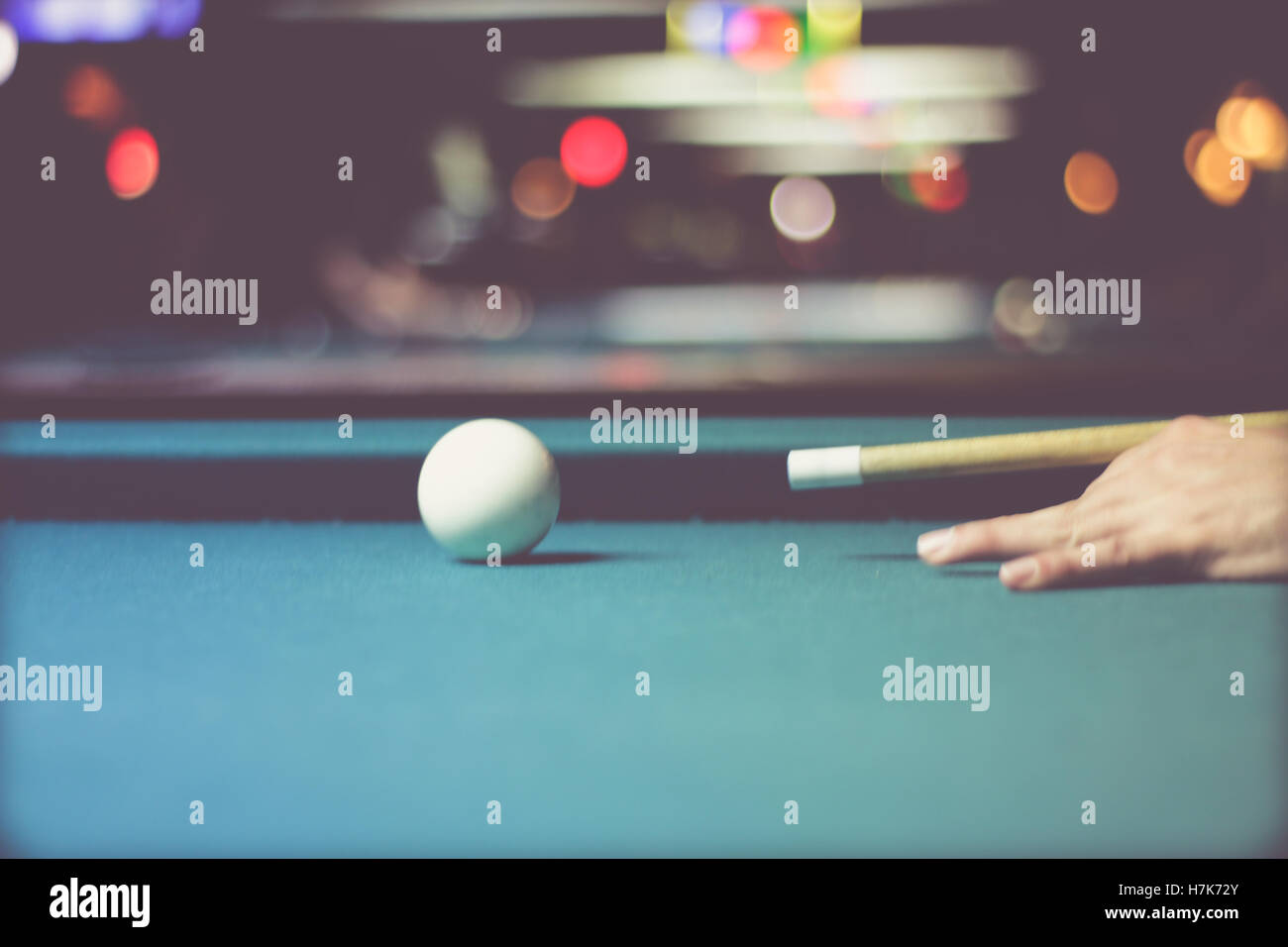 Photograph of a hand holding a pool stick on a billiards table Stock ...